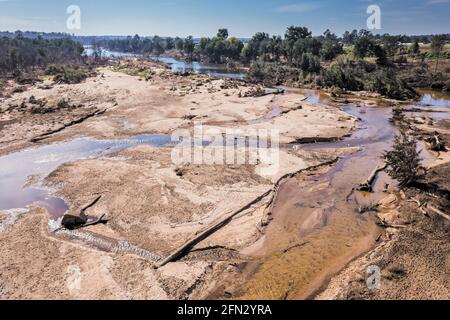 Drone aerial photograph of flood water on a dirt road in a forest in ...