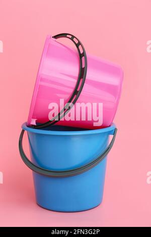 Plastic buckets on color background Stock Photo - Alamy
