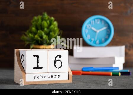 February 16th. Day 16 of month, Calendar date. Hand click luminous icon ...