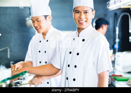 Portrait of young chefs cooking together Stock Photo - Alamy