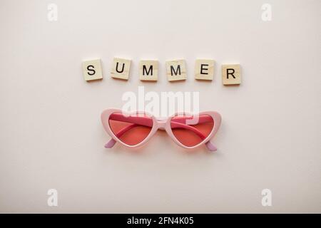 Layout. Pink glasses in the form of hearts on a light pink background ...