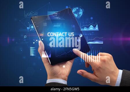 Businessman holding a foldable smartphone, business concept Stock Photo ...