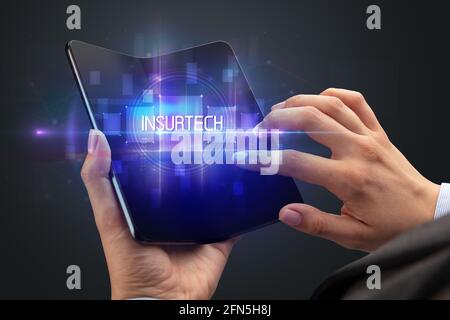 Businessman holding a foldable smartphone with PRIVACY ALERT ...