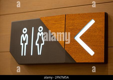 Closeup of comfort room signage with an arrow sign showing the ...