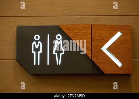 Closeup of comfort room signage with an arrow sign showing the ...