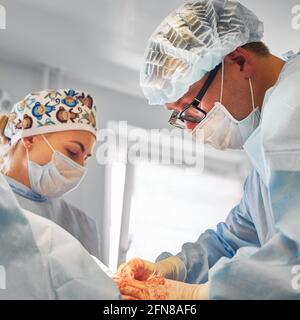 Male doctor conducting abdominoplasty surgery in operating room Stock ...