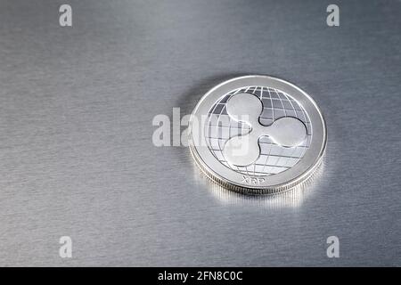 Ripple coin, XRP token, cryptocurrency on red background Stock Photo ...