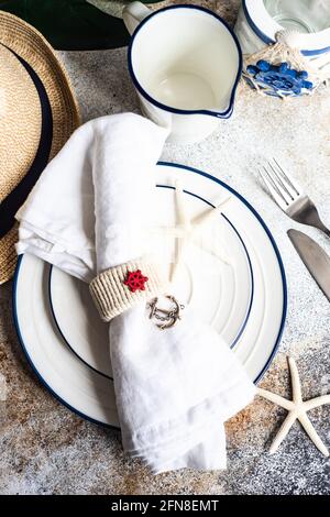 Marine table setting on concrete table as a summer background concept ...