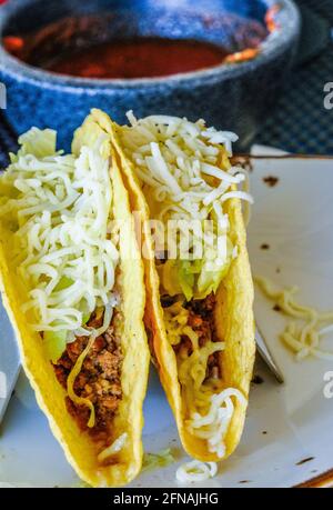 Two taco shells on red background Stock Photo - Alamy