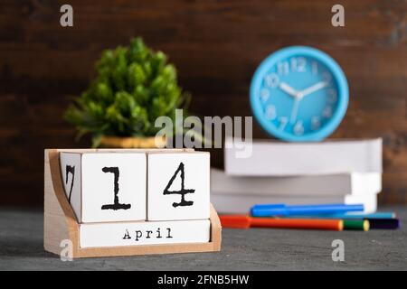 April 14th. April 14 wooden cube calendar with blur objects on ...