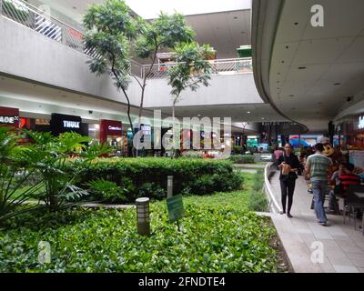 Shoppers sit and walk around Mall of Asia, Metro Manila, Philippines ...