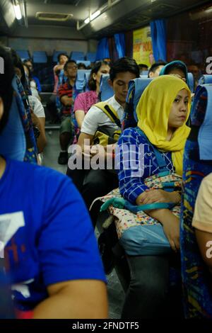 Asian Filipino aircon bus passengers wait as the bus departs from the ...