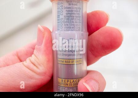 Close-up of an 'EpiPen' logo on a yellow epinephrine autoinjector box ...