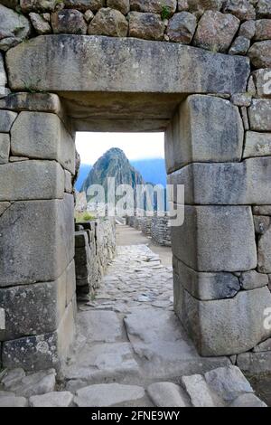 Machu Picchu, gate in the ruined city of the Incas with the Mount Huayana Picchu, Andes ...