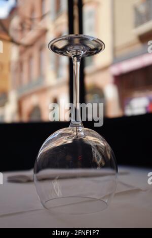 A wine glass turned upside down and a stubbed out cigarette Stock Photo ...