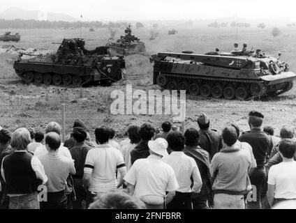 Soldiers demonstrate weapons and equipment to civilians. Here an ...
