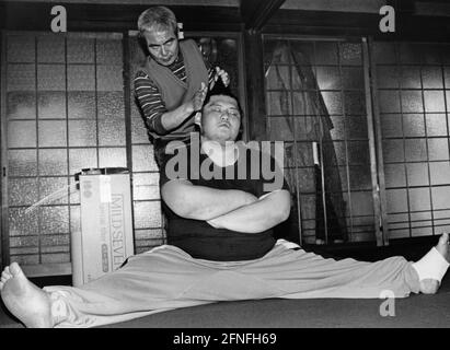 Big fat obese overweight Sumo wrestler warms up and stretches before ...
