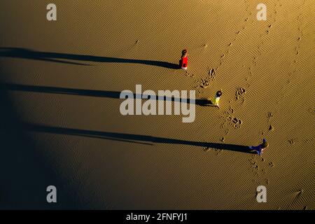 3 girls wearing colorful Cham traditional clothes on their way to the ...