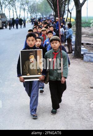 China, Beijing, February 1971 Photo: students singing in front of a Mao ...