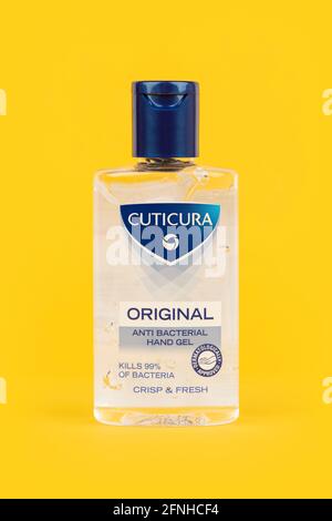 A bottle of Cuticura original anti bacterial hand gel shot on a yellow ...