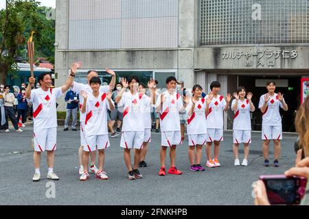 Local torchbearers pose during the Tokyo 2020 Olympic torch relay in ...