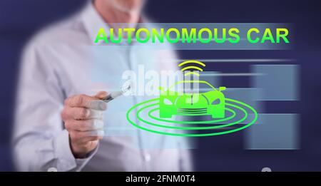 Man touching an autonomous car concept on a touch screen with his ...