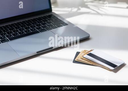 few credit deposit cards on the table near laptop copy space Stock ...