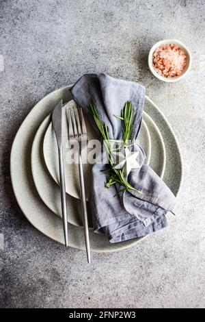 Minimalistic table setting with rosemary Stock Photo - Alamy