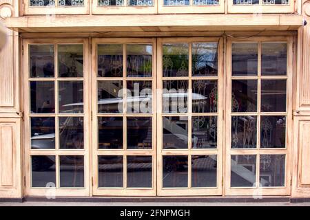 the facade of the restaurant with panoramic beige wooden windows and ...