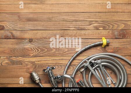 Set of plumber's items on wooden background Stock Photo - Alamy
