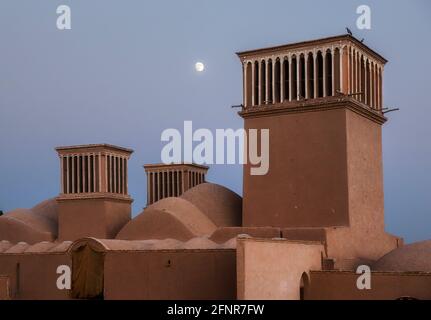 View of the city with traditional wind catchers and mosques at dusk ...