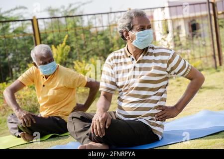 Elderly people relax on fitness equipment in Wenfeng Park, with a group ...