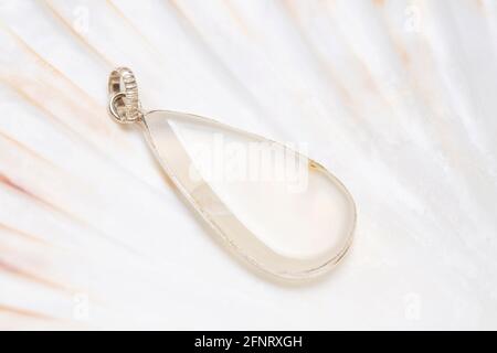 Metal frame mineral stone pendant on white shell background Stock Photo ...