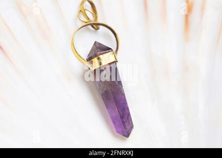 Metal frame mineral stone pendant on white shell background Stock Photo ...