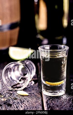 several glasses with mezcal (or mescal) is commonly known as "tequila ...