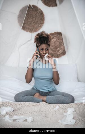 Young woman crying looking at smartphone screen Stock Photo - Alamy