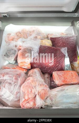 Frozen food in the freezer. Bagged frozen meat and other foods in a ...