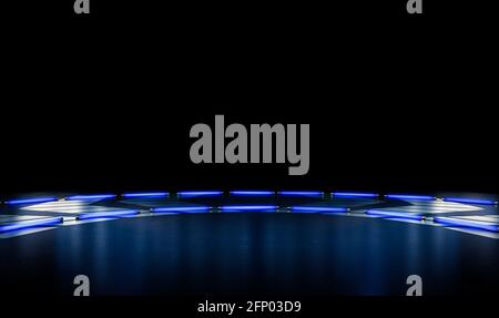 A black reflective stage setting with silver designs lit by a circular ...