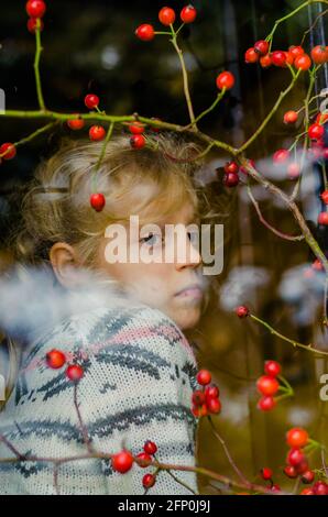 adorable blond girl portrait behind the window in autumn time Stock ...