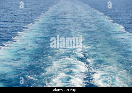 The churning blue water of a cruise ship wake on the Atlantic Ocean ...