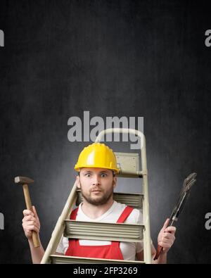 Portrait of a clumsy worker with tools Stock Photo - Alamy