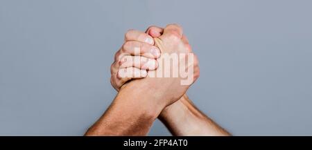 Arms wrestling. Closep up. Friendly handshake, friends greeting ...