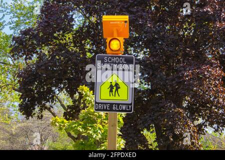Blinking school safety zone sign Stock Photo - Alamy