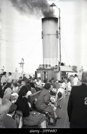 People sitting aboard River Thames steam packet ferry boat either SL ...