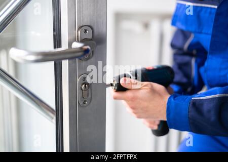 Locksmith Man Repairing And Changing Metal Door Lock Stock Photo - Alamy