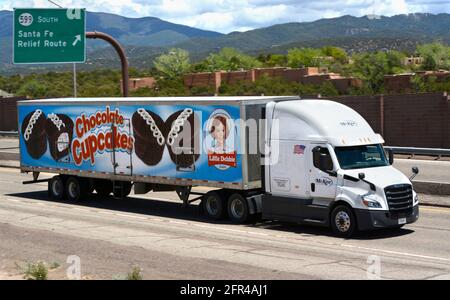 A tractor trailer delivering Little Debbie brand snacks travels along a ...
