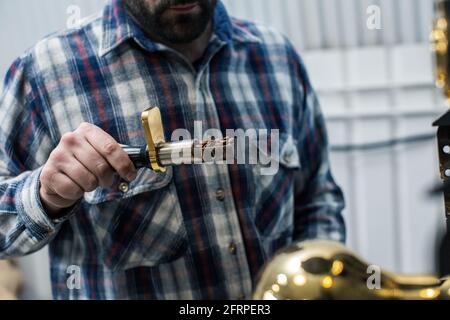 A coffee roaster checks coffee beans during roasting Stock Photo - Alamy