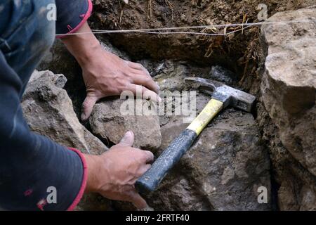 a stonemason working with stone, craft for construction and ...