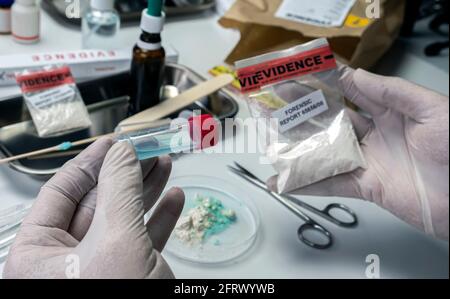 Police scientist holds drug-positive swab, crime lab, concept image ...