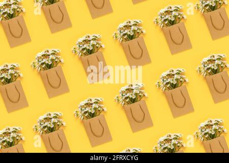 Pattern with field chamomiles flowers in craft package on yellow ...